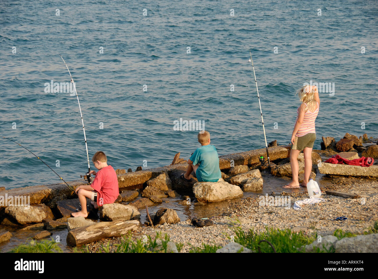 Family having fun fishing on a warm summer day in the Maumee River at ...