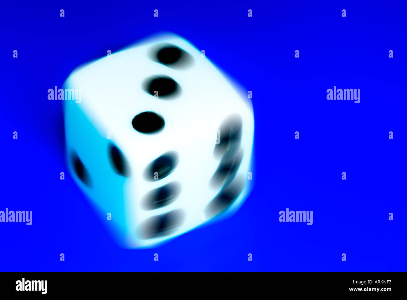 white spinning die concept image Stock Photo - Alamy