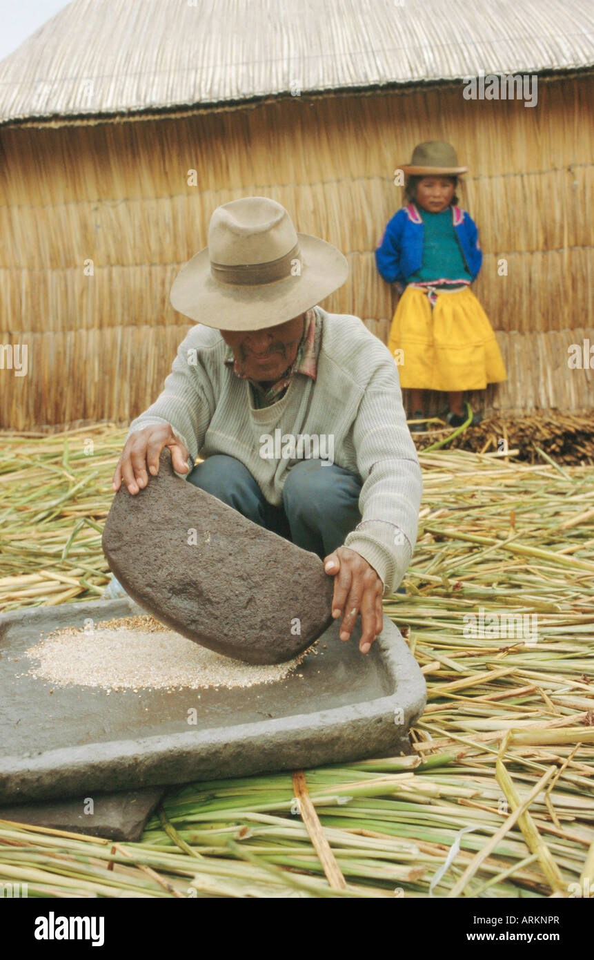 Man making flour by the traditional method of grinding, floating reed ...