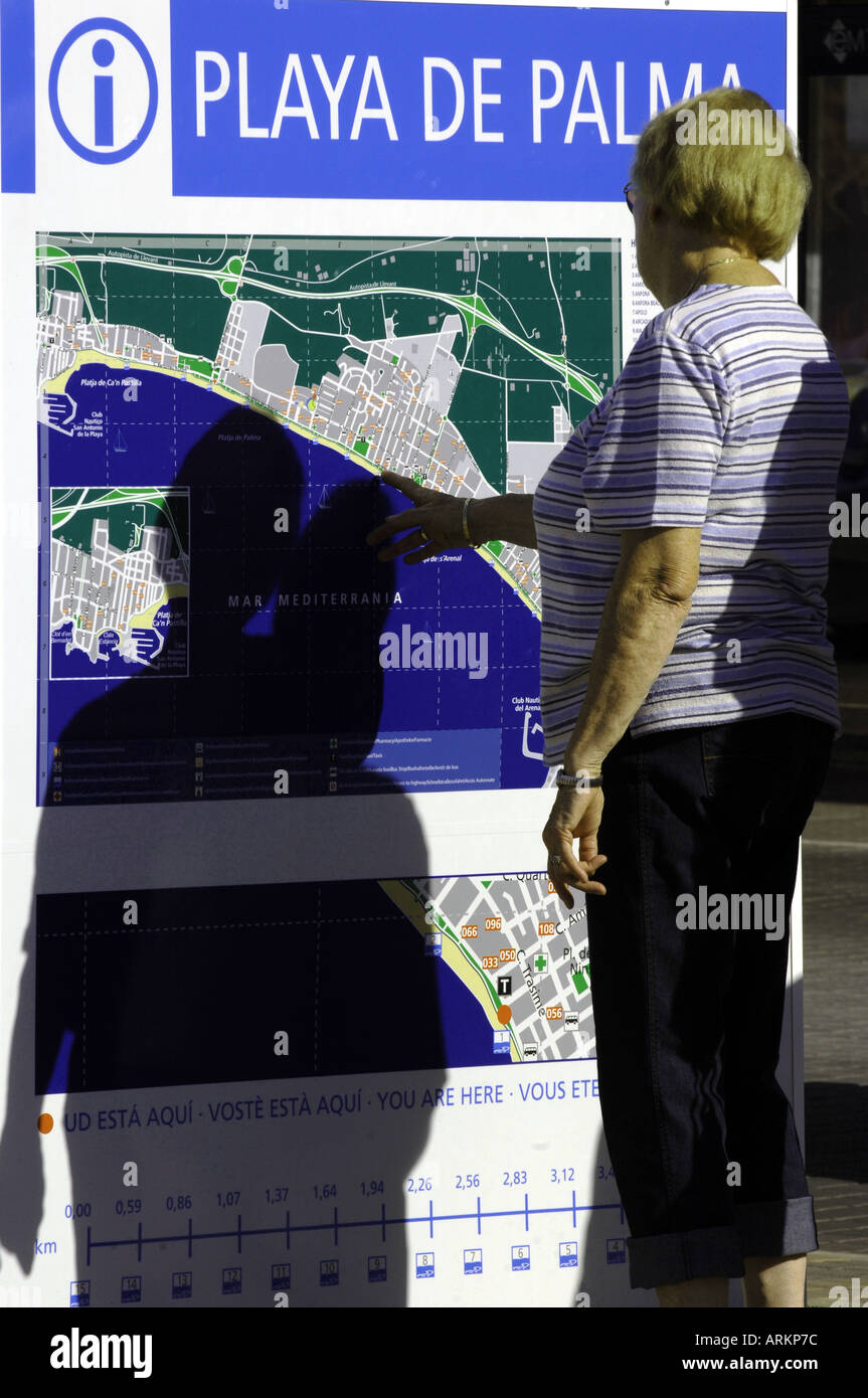 female, woman tourist reading sign Stock Photo - Alamy