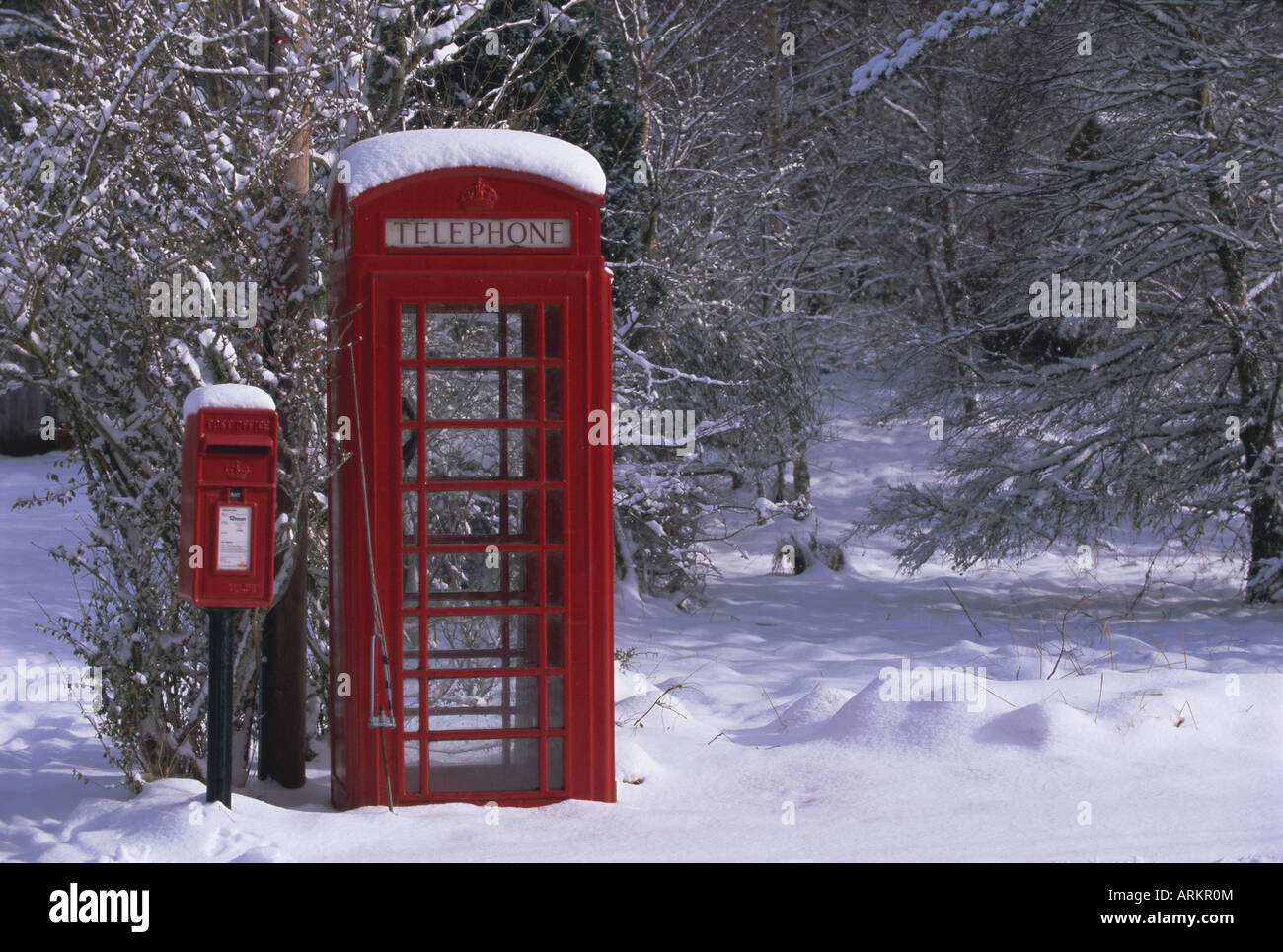 Red letterbox and telephone box in the snow, Highlands, Scotland, UK ...