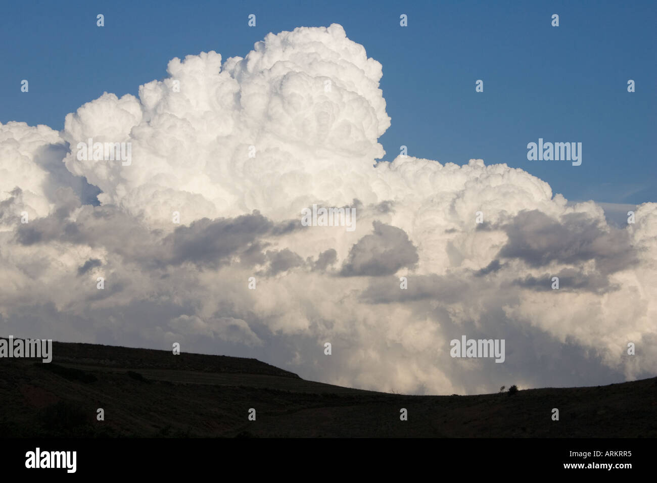 Low altitude billowing cumulus clouds on horizon looming above dark ...