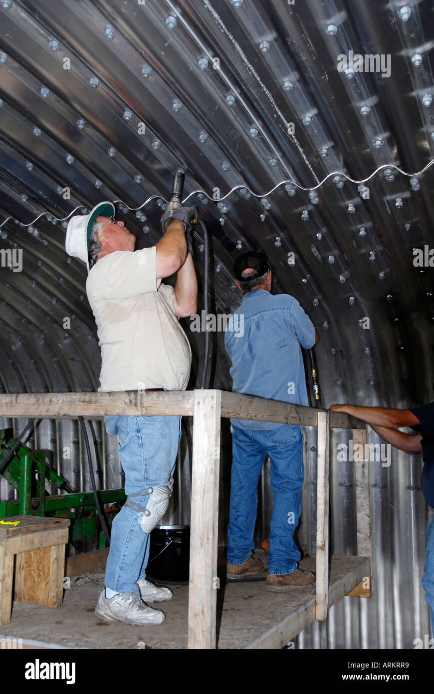 Construction workers use heavy tools to build steel culvert Stock Photo ...
