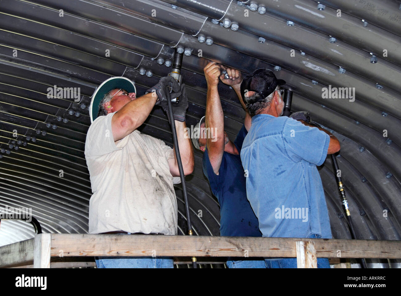 Construction workers use heavy tools to build steel culvert Stock Photo ...