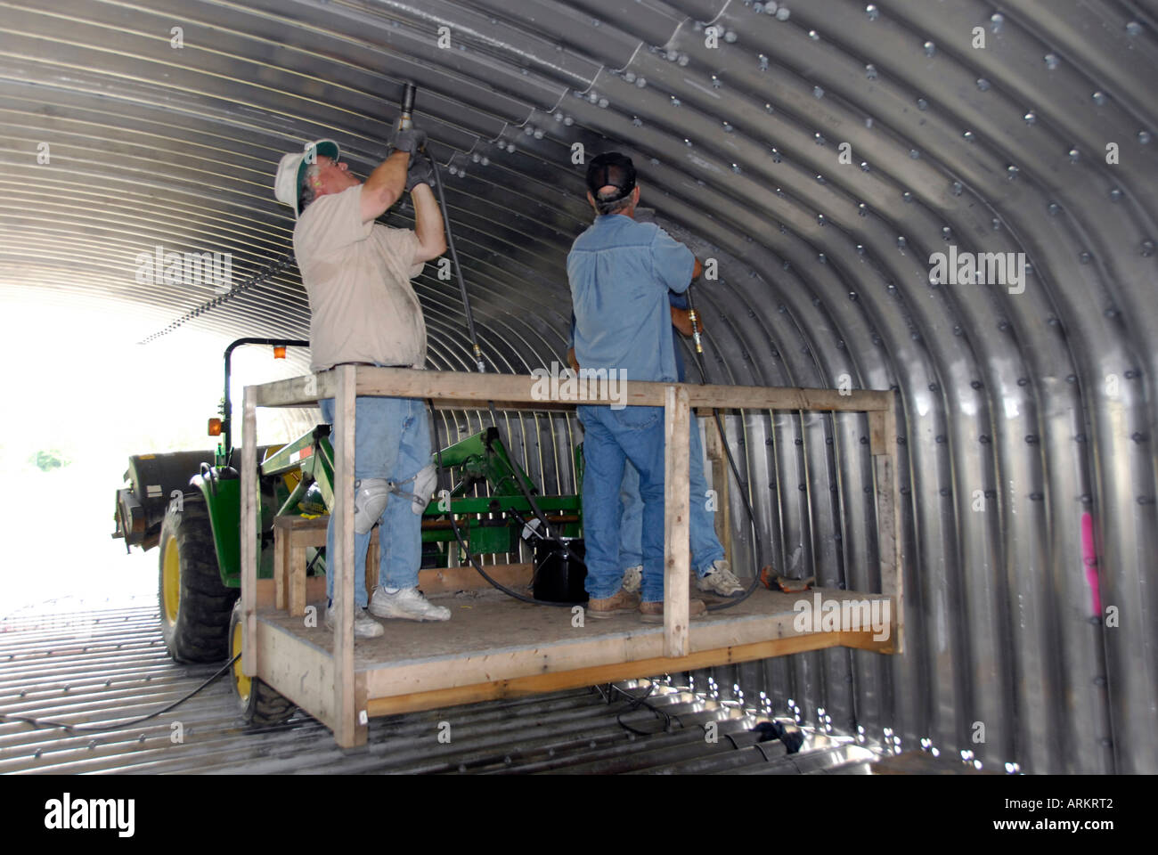 Construction workers use heavy tools to build steel culvert Stock Photo ...