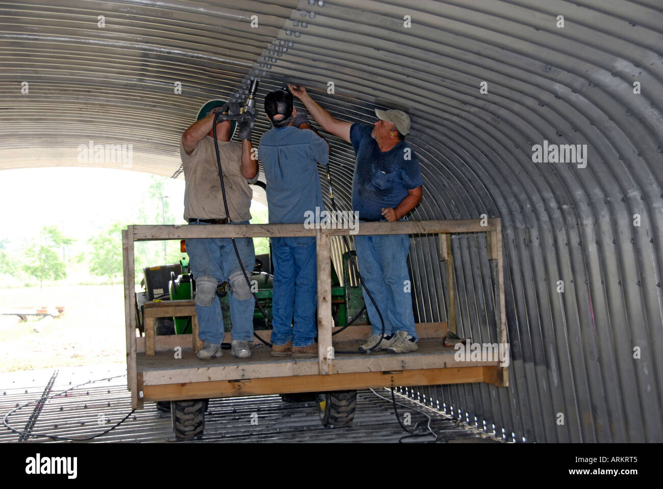 Construction workers use heavy tools to build steel culvert Stock Photo ...