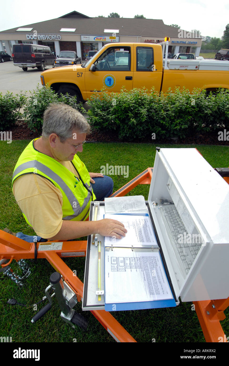 County road commission worker programs a sign for oncoming traffic ...