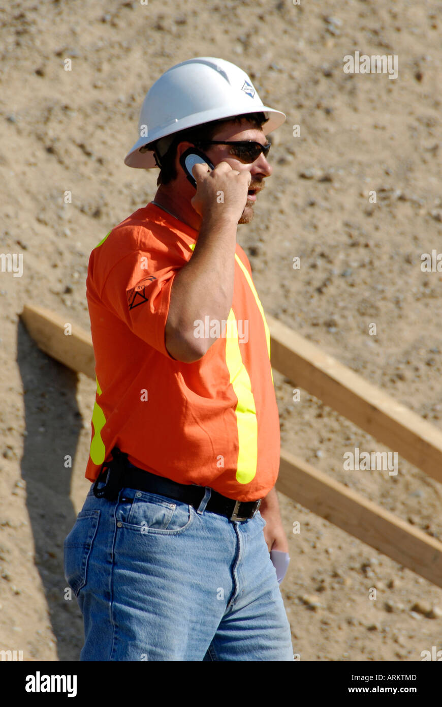 Construction worker talks on a cellular cell phone Stock Photo - Alamy