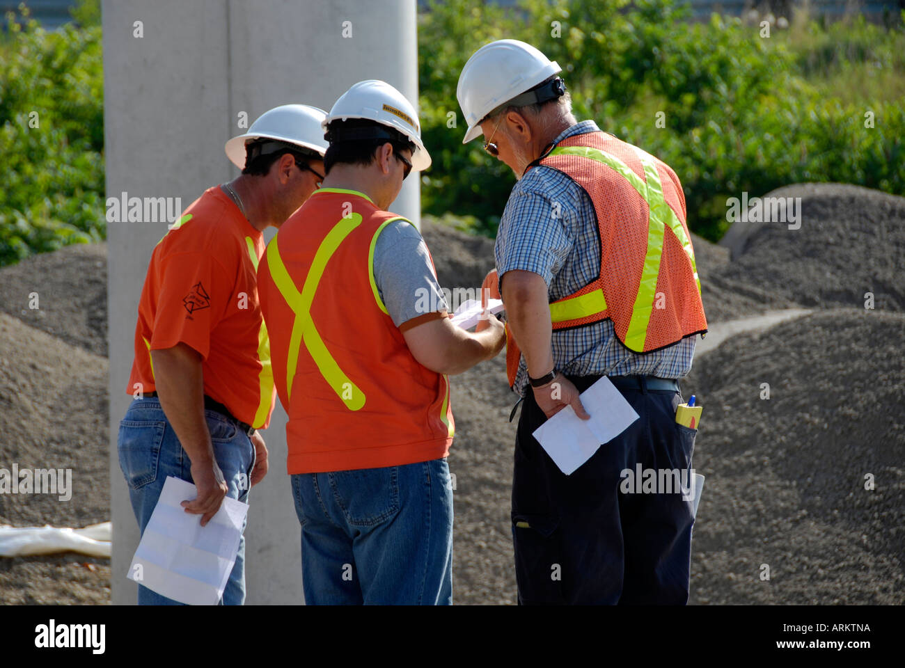 Construction crew talks about next phase of a project Stock Photo - Alamy