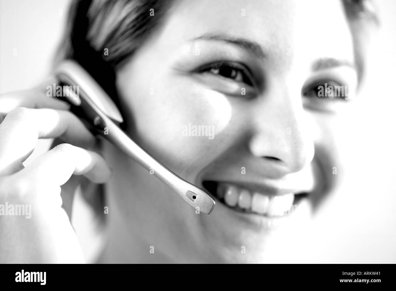 Woman adjusting microphone headset hi-res stock photography and images ...