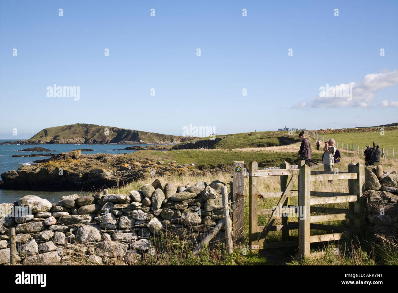ISLE of ANGLESEY COASTAL PATH kissing gate stone wall with birdwatchers ...