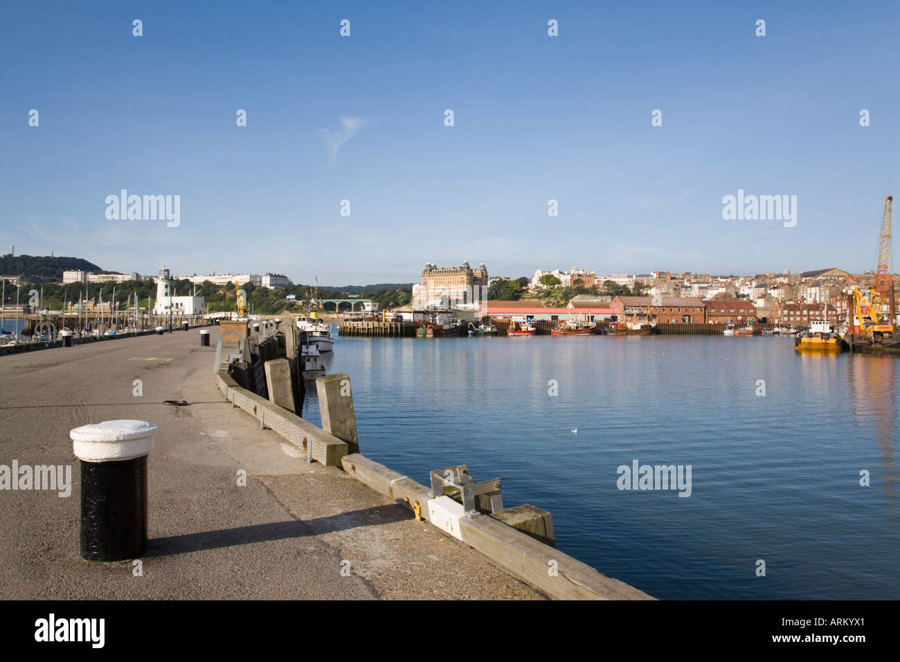 Capstan on pier by Old Harbour with lighthouse at entrance in South Bay ...