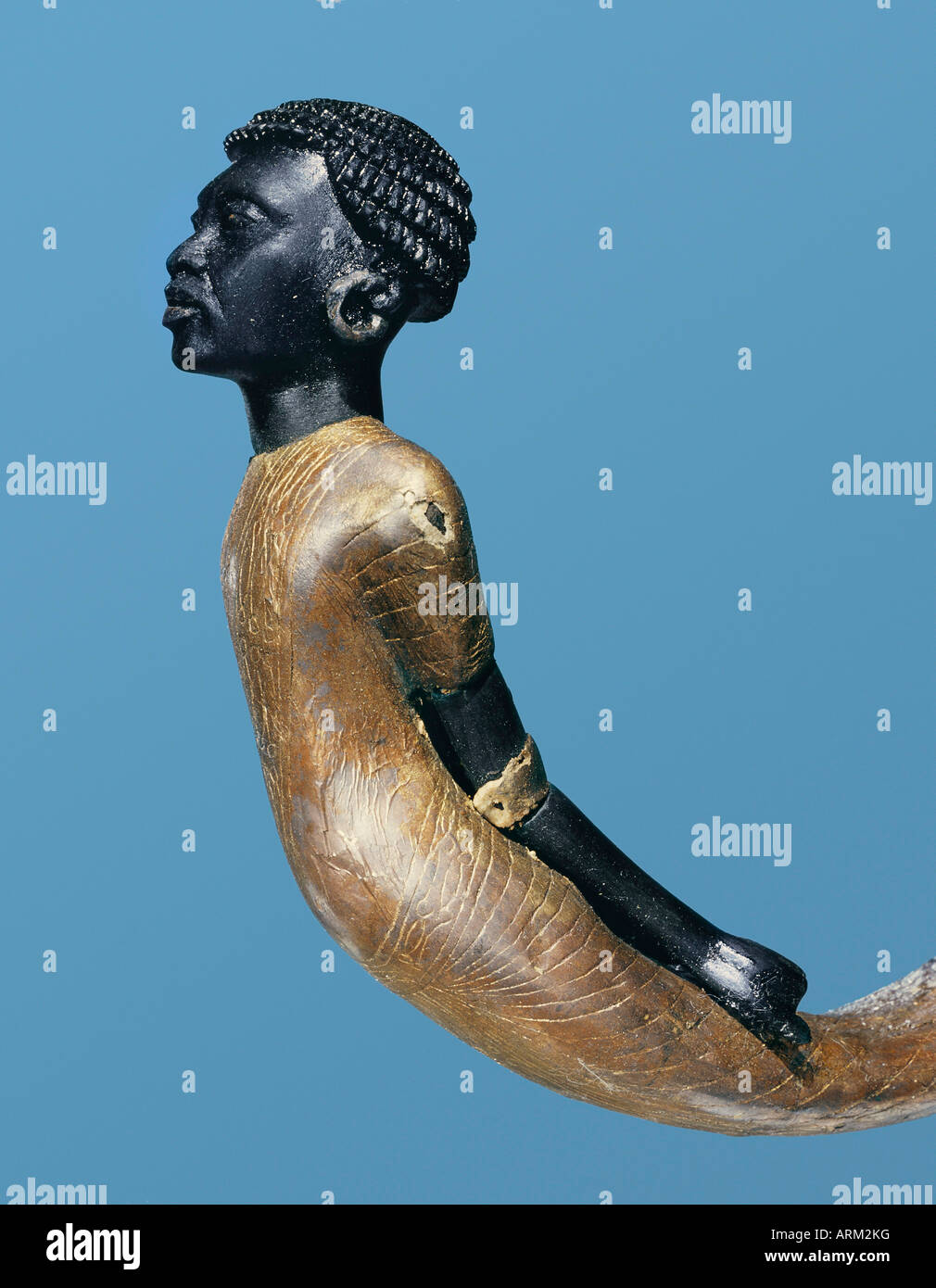 An African adversary carved on the lower end of a ceremonial cane, from ...