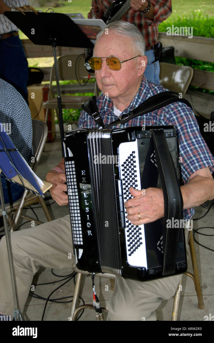 Old musicians play music at a senior citizen gathering in a public park ...