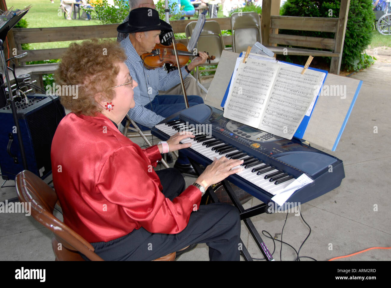 Old musicians play music at a senior citizen gathering in a public park ...