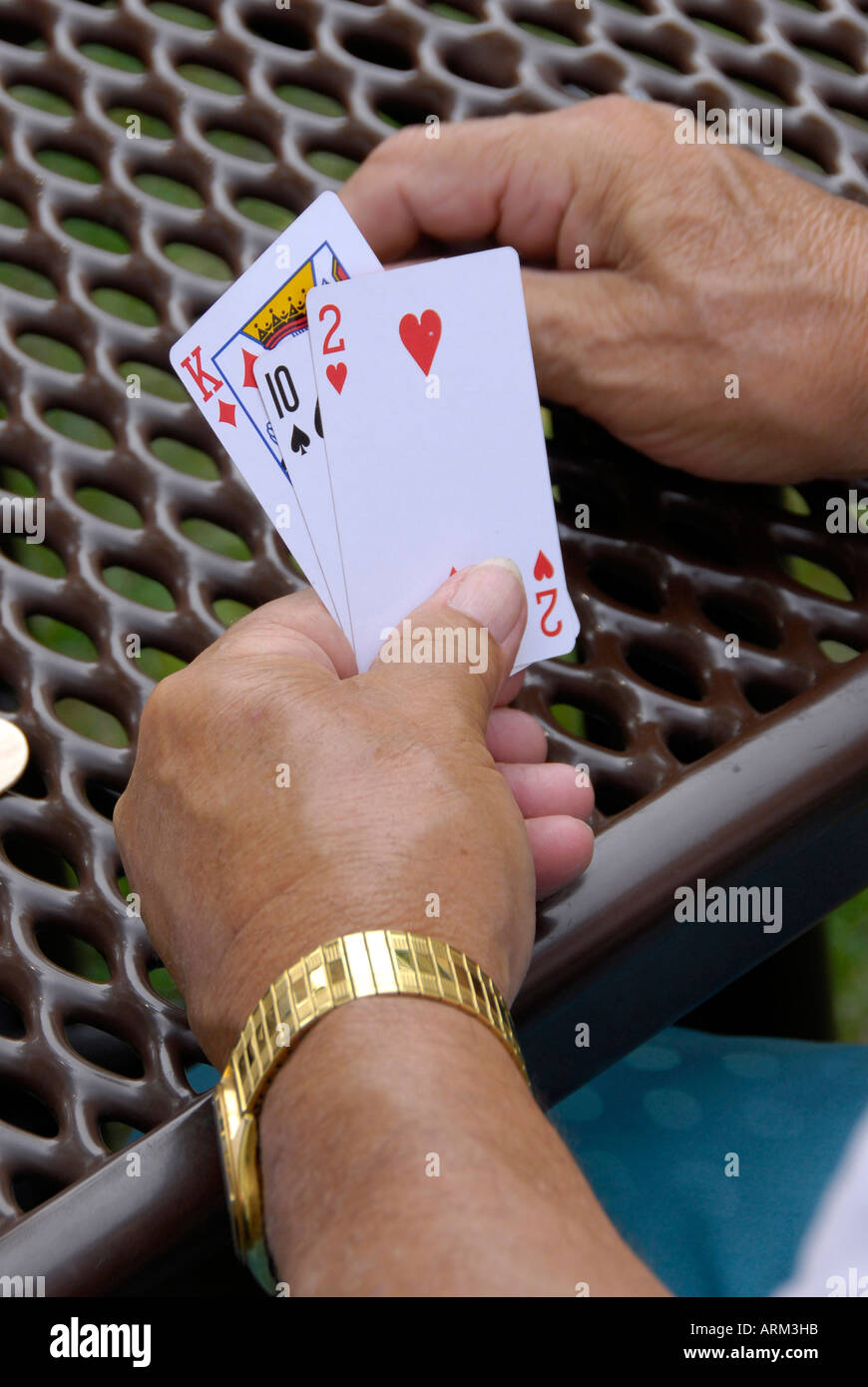 Hands holding playing cards hi-res stock photography and images - Alamy
