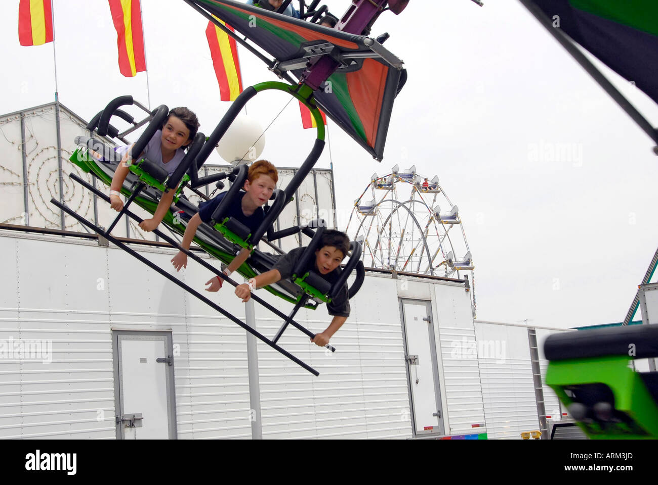 Kids ride exciting and daring rides at a carnival festival Stock Photo ...