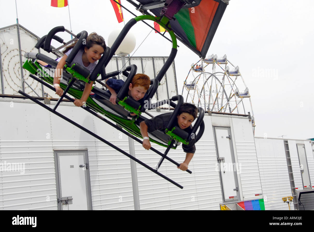 Kids ride exciting and daring rides at a carnival festival Stock Photo ...