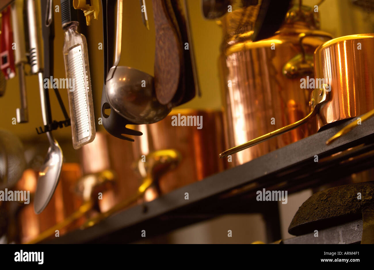 COOKING UTENSILS HANGING UP IN A KITCHEN Stock Photo - Alamy
