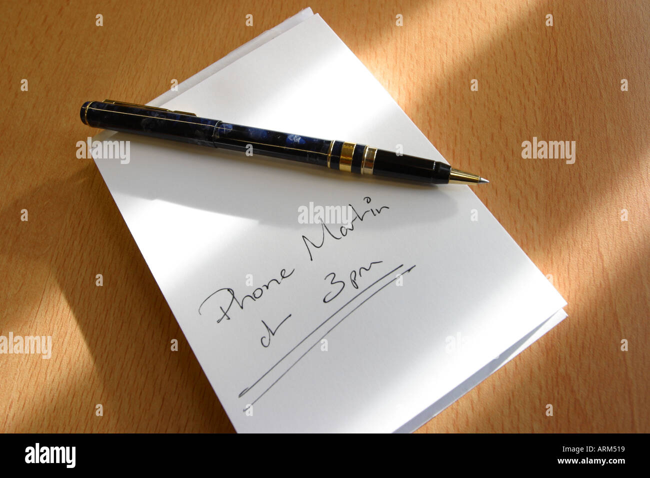 Message written on notepad with pen on desktop reminder to make Phone ...