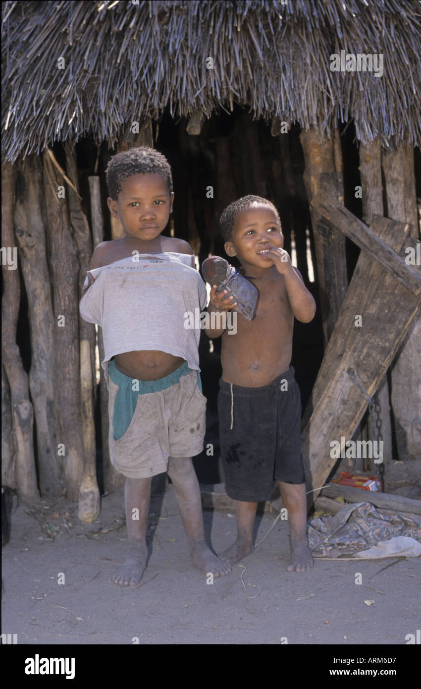 BUSHMEN BOYS OUTSIDE MUD HUT Stock Photo - Alamy