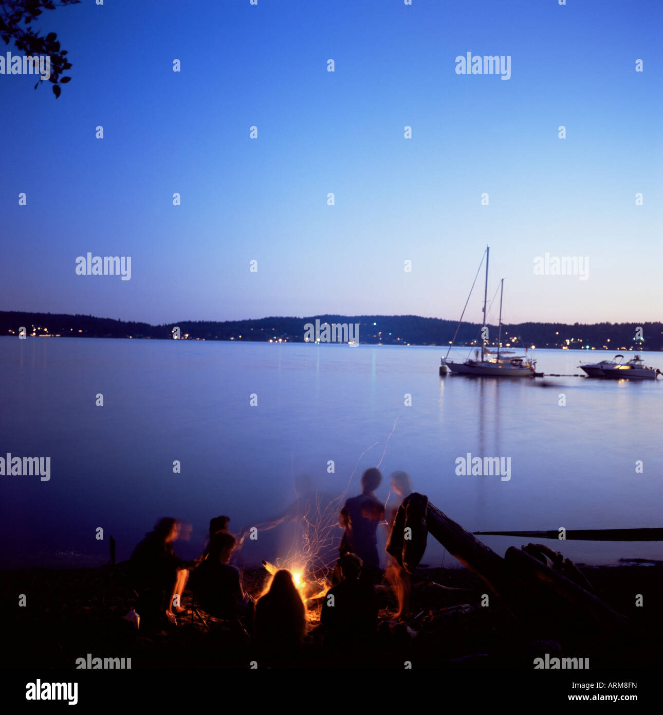 Friends around beach fire, Blake Island, Puget Sound, Washington State ...