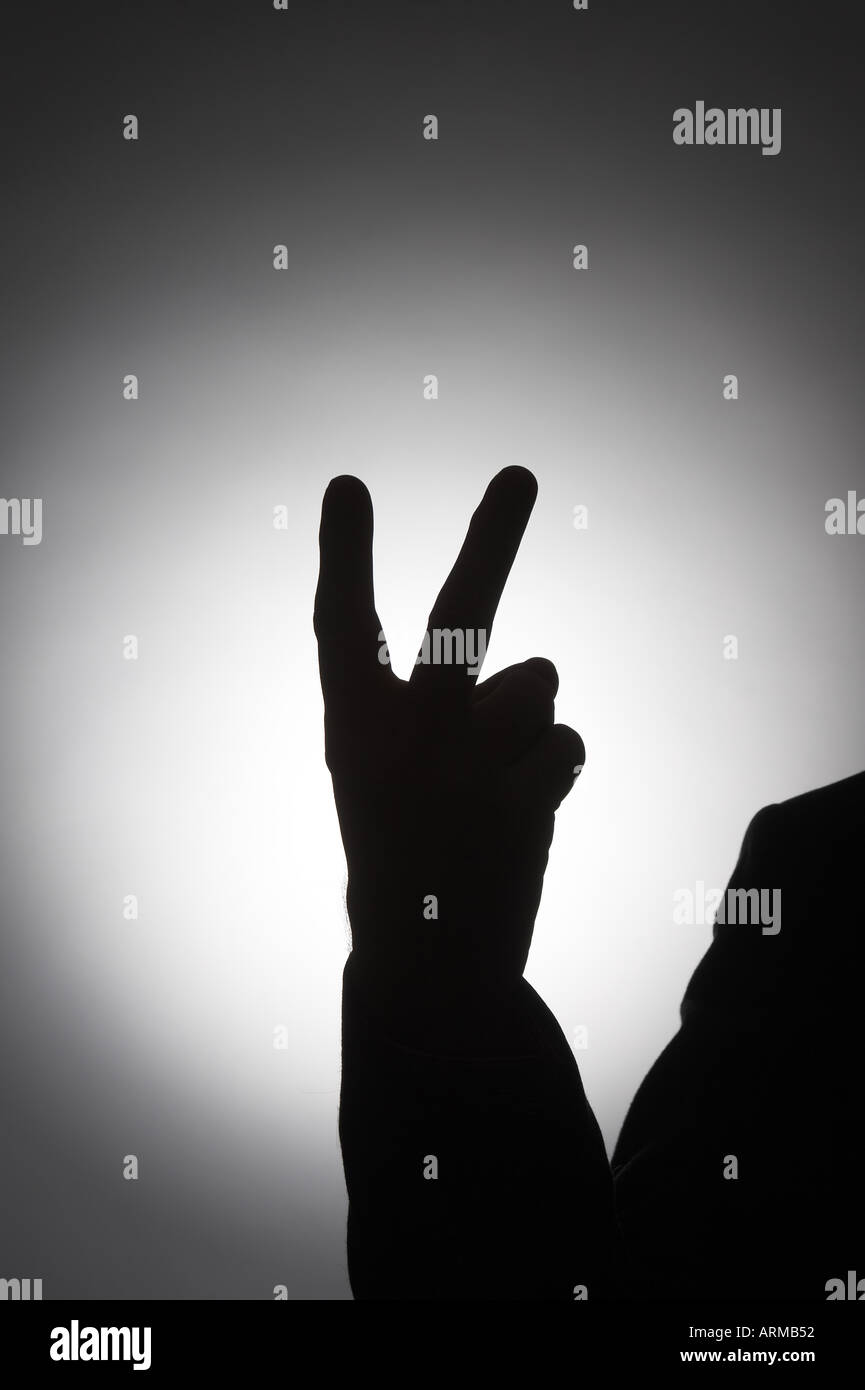 Silhouette of male hand making rude offensive V sign gesture with two ...