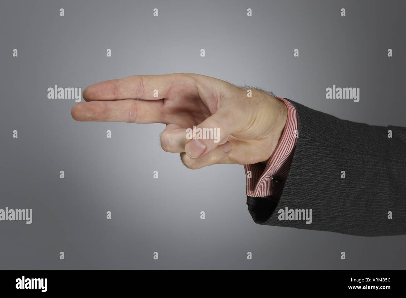 Male hand making pistol gun sign gesture of aggression Stock Photo - Alamy