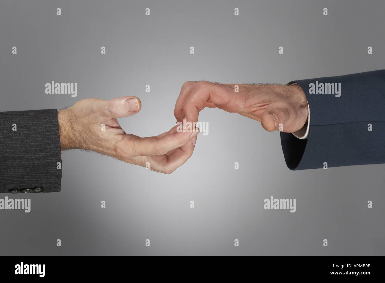 Delicate finger contact handshake of two corporate business men in ...
