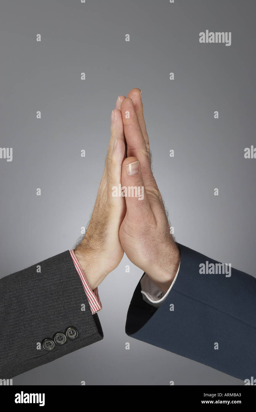 High five gesture of two corporate business men in suits male hands ...