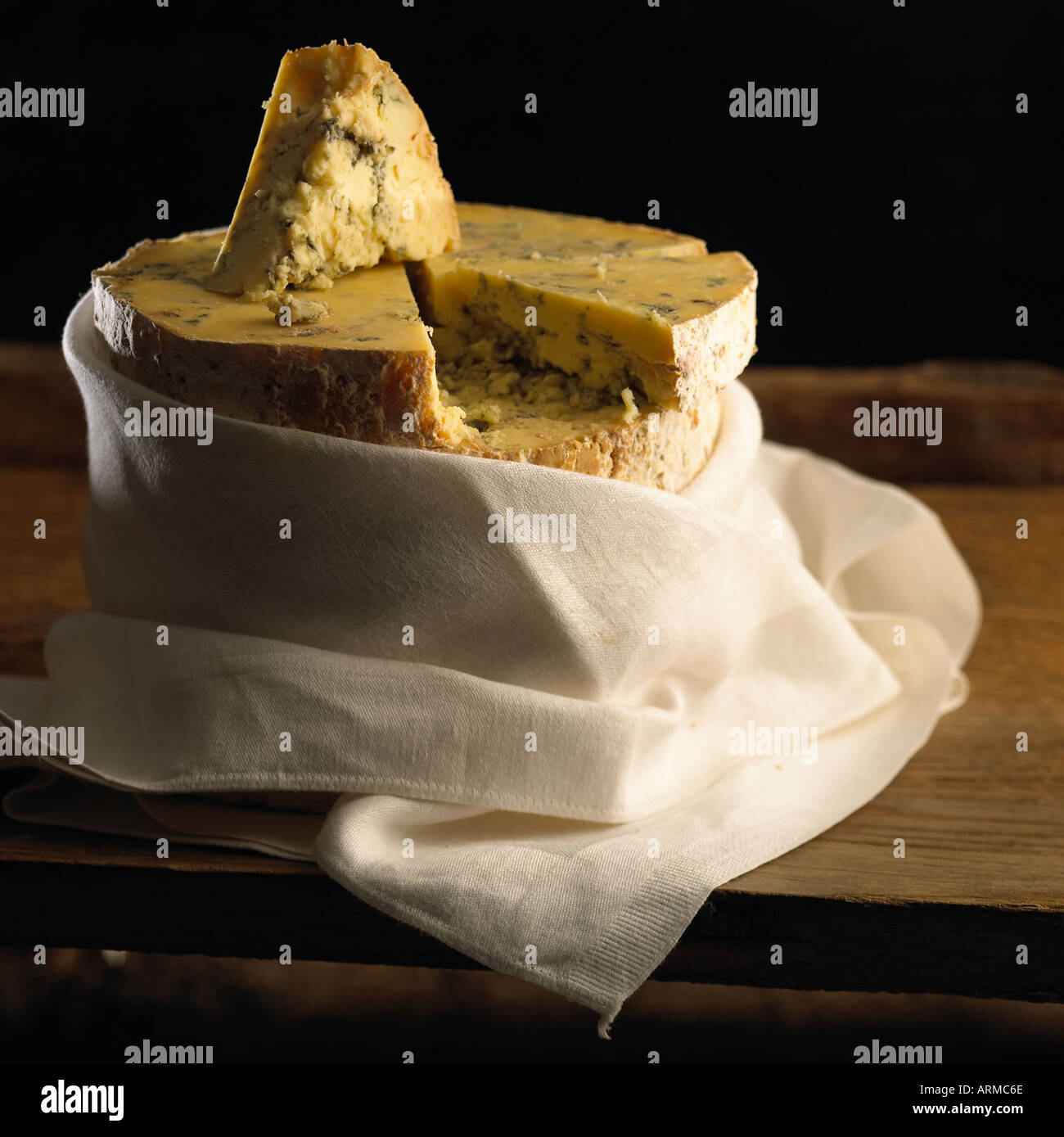 Stilton Cheese Whole baby truckle wrapped in linen cloth with wedge cut ...