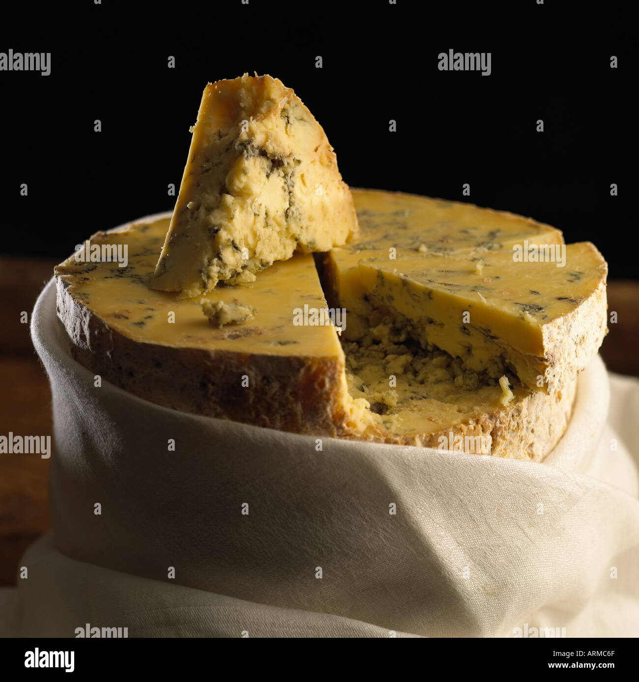 Stilton Cheese Whole baby truckle wrapped in linen cloth with wedge cut ...