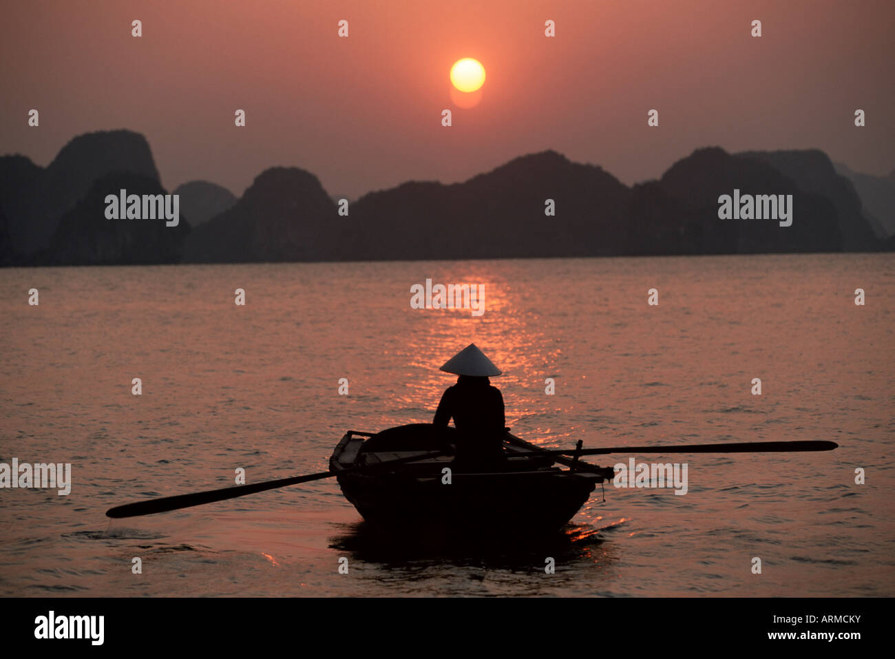 Woman rowing woven skiff, Ha Long Bay (Ha-Long Bay), UNESCO World ...