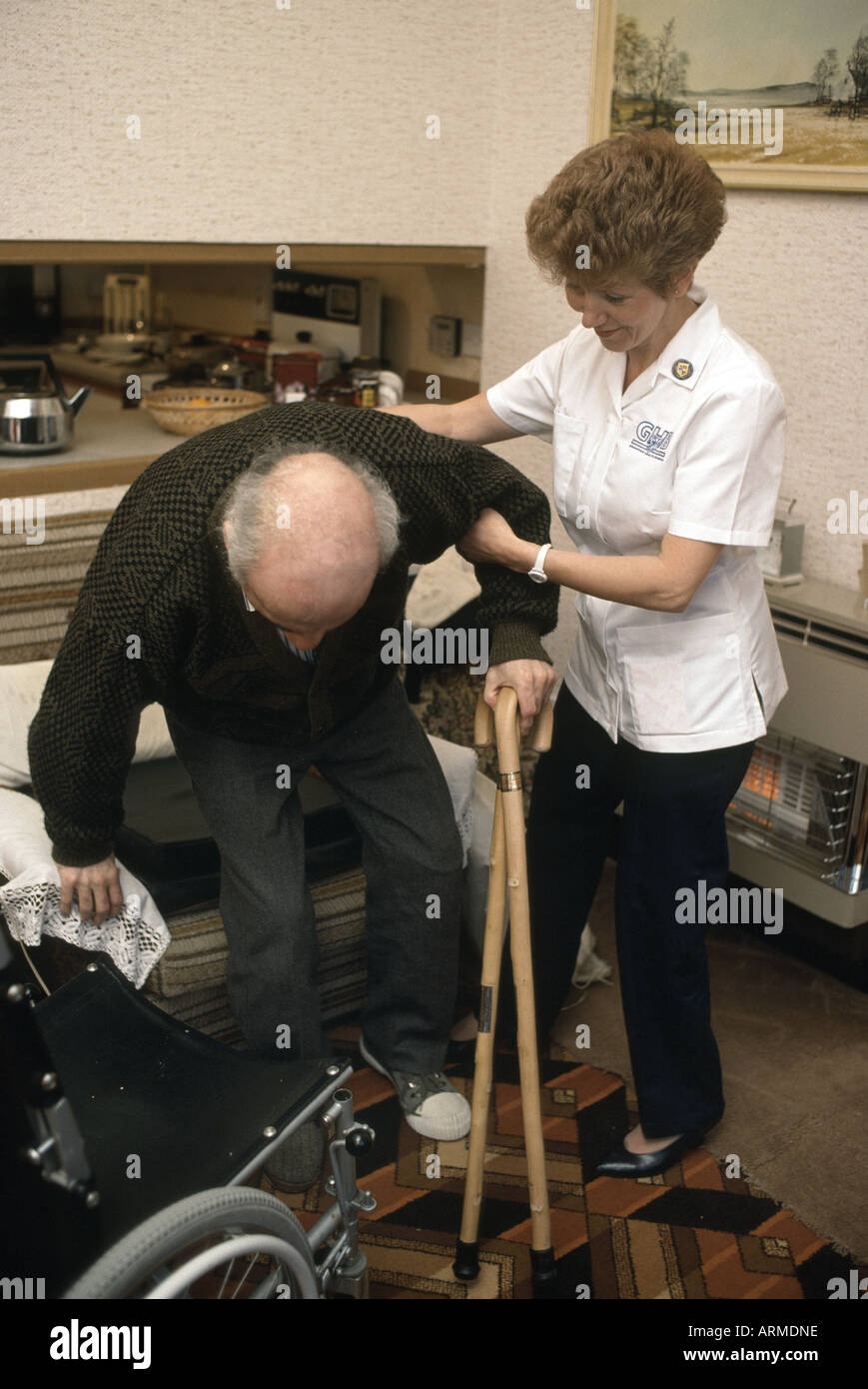 Health visitor assisting an old man with his canes Stock Photo - Alamy