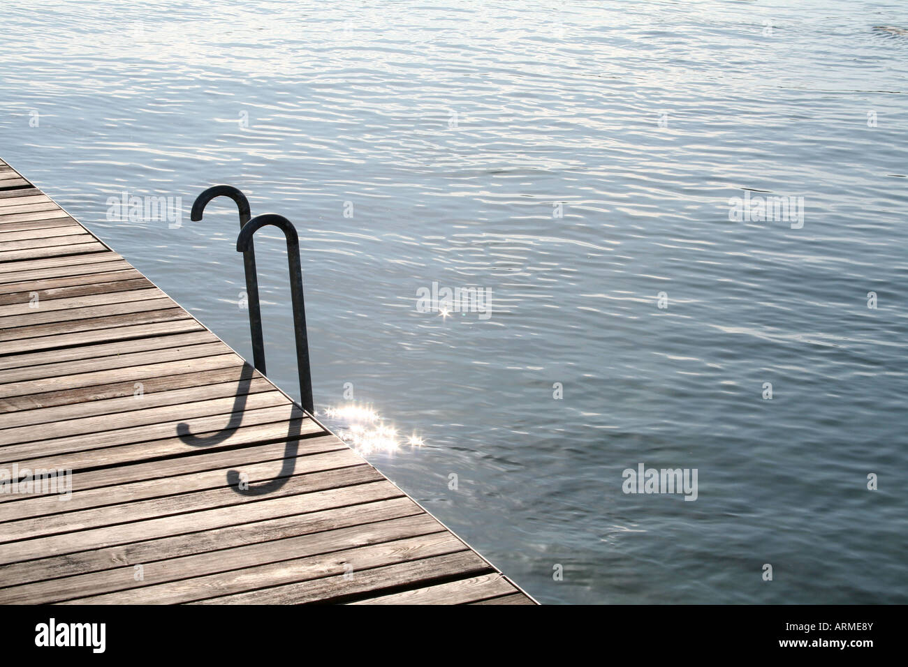 Wooden waterside walkway with ladder into the water Stock Photo - Alamy