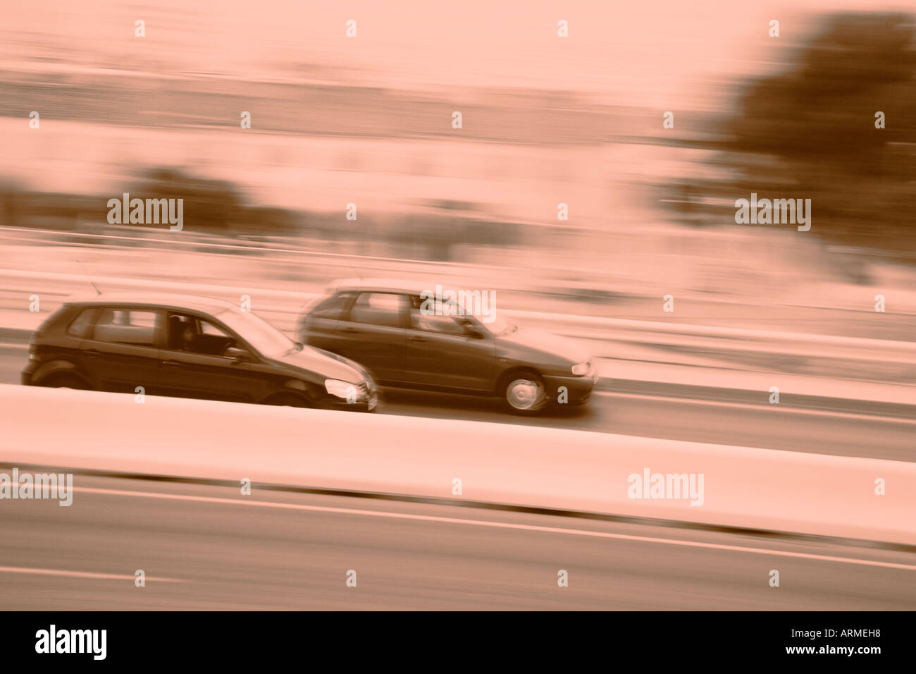 Two cars speeding along motorway Stock Photo - Alamy