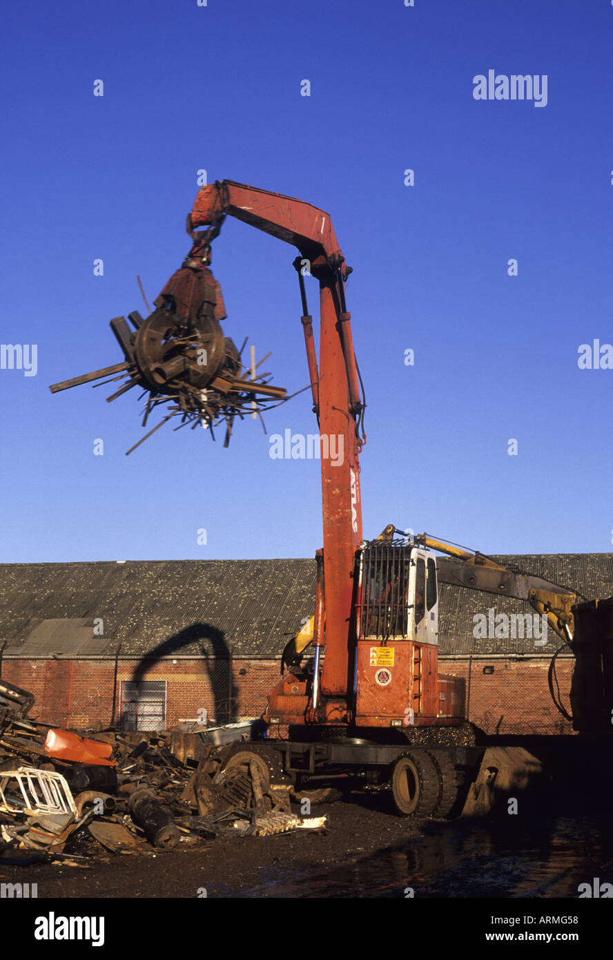 hydraulic grab on crane lifting load of scrap metal for recycling at ...