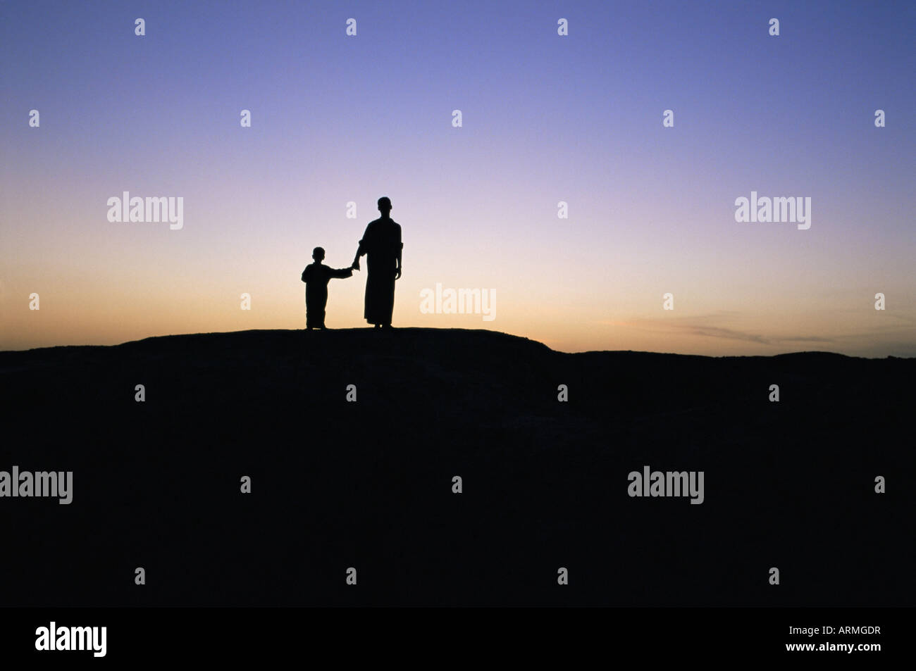Silhouette of two people at the archaeological area, Kish, Iraq, Middle ...