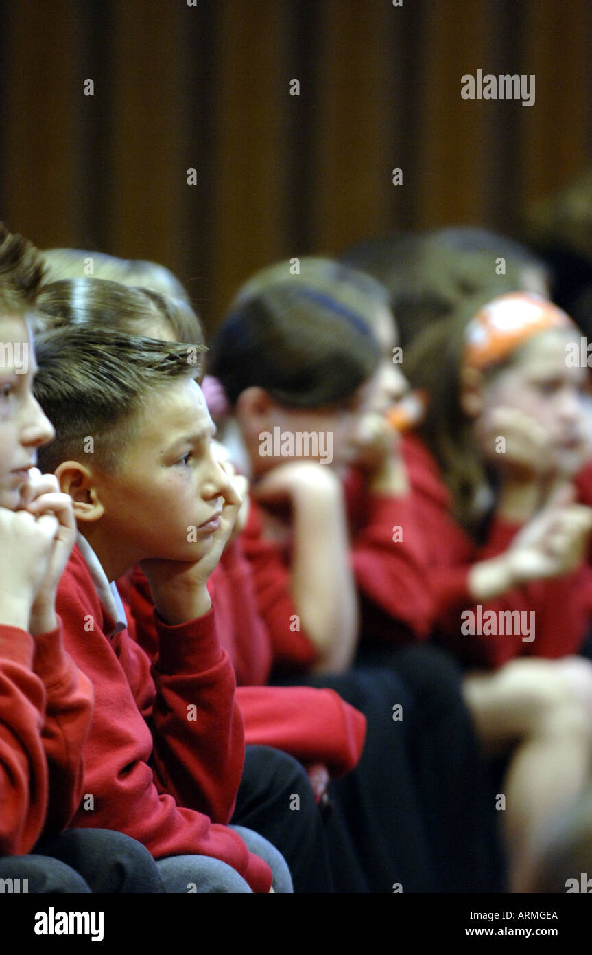 children sitting bored in assembly, watching, listening, well behaved ...