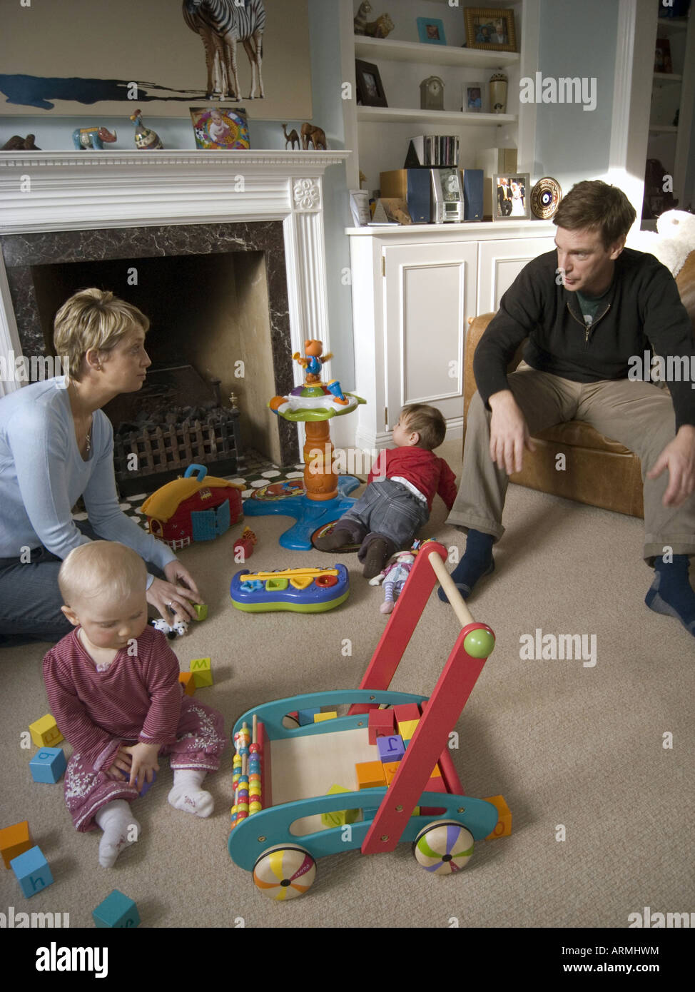 Parents looking after children home Stock Photo - Alamy