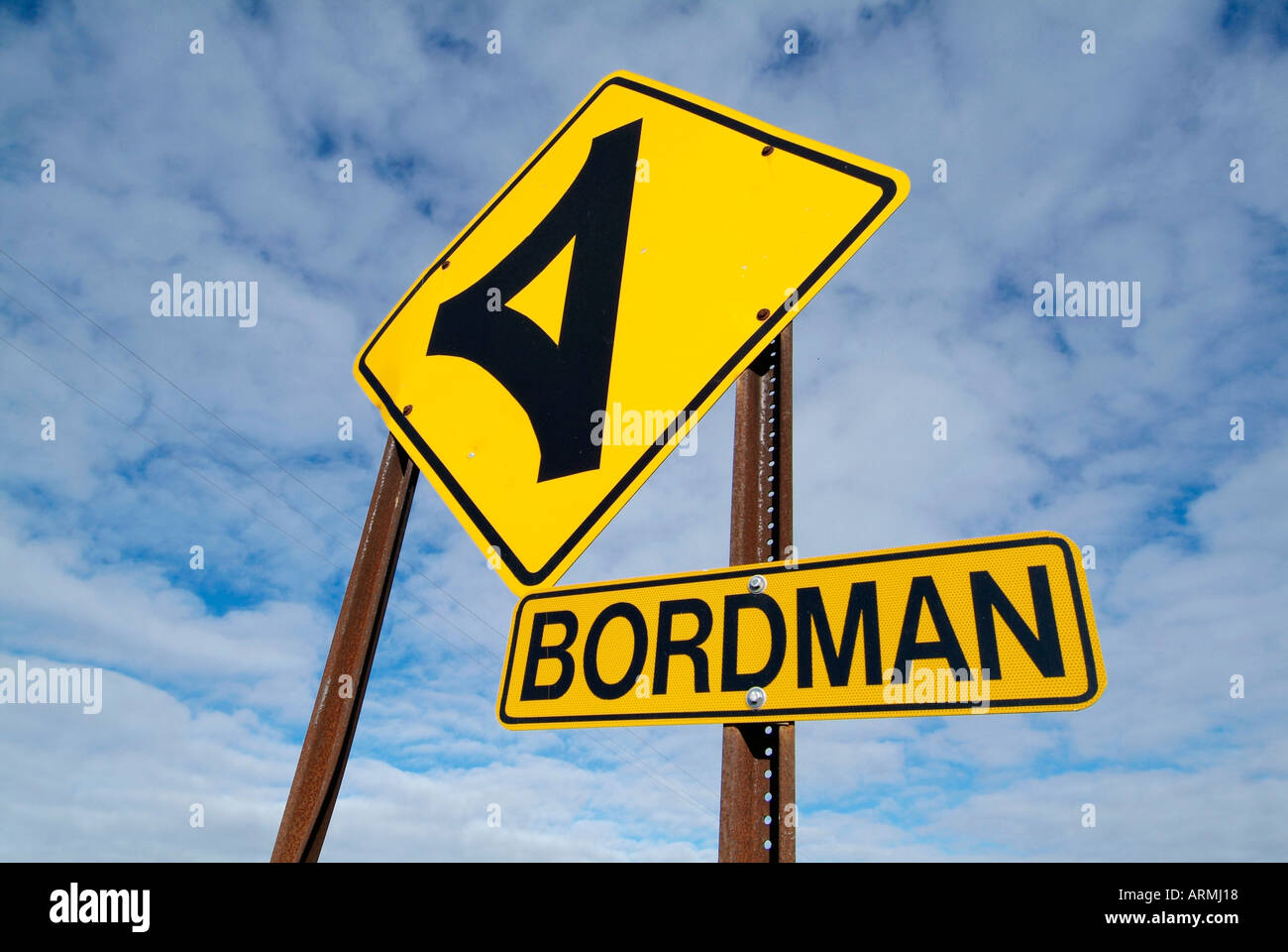 Traffic sign alerting motorist drivers that two roads meet one road ...