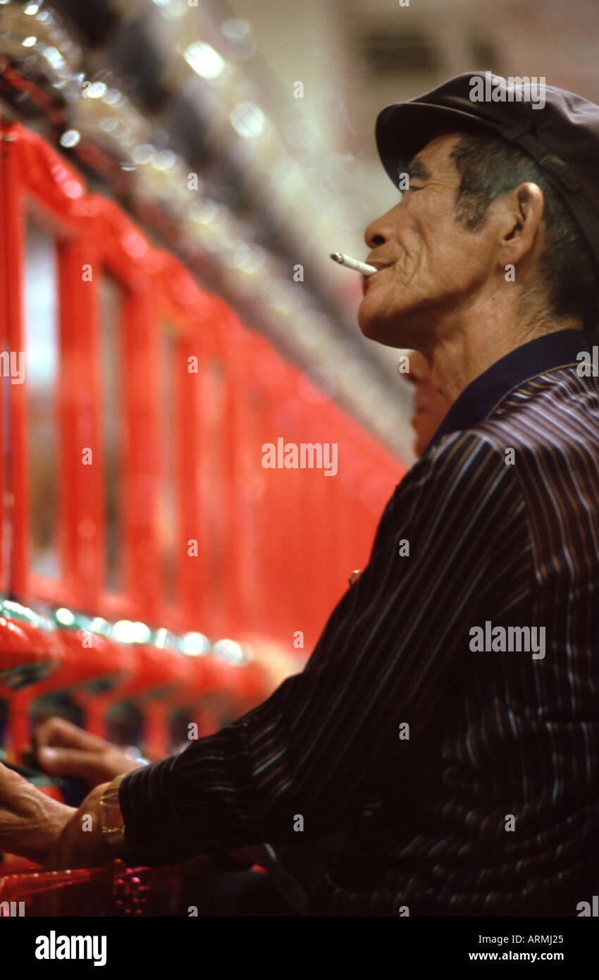 Old Japanese man playing pachinko Stock Photo - Alamy