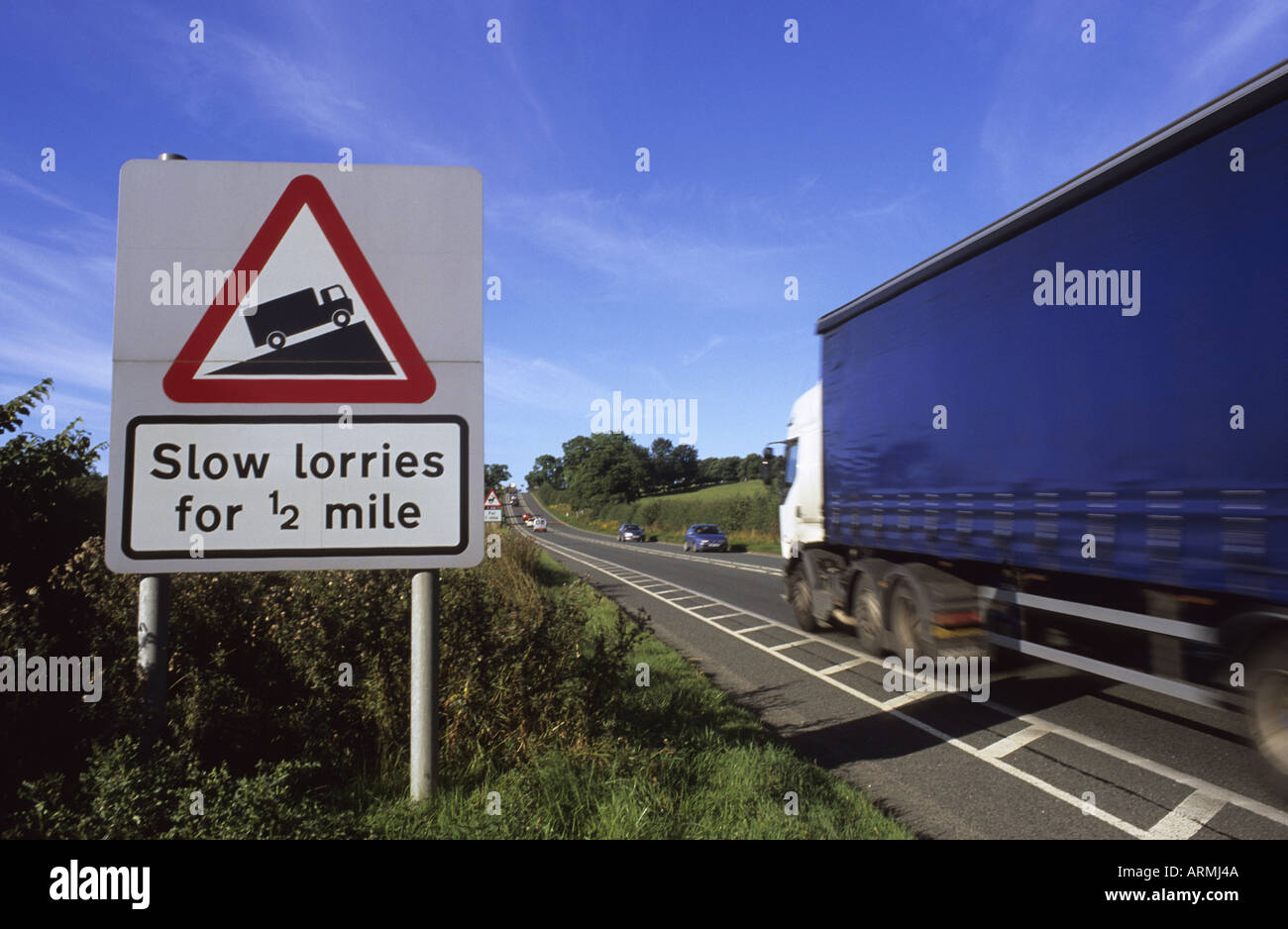 lorry passing warning sign of slow lorries travelling in the road ahead ...