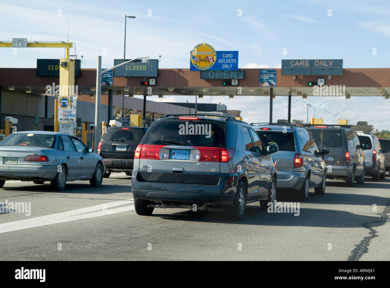 Customs and immigration agents check automobiles entering the U S ...