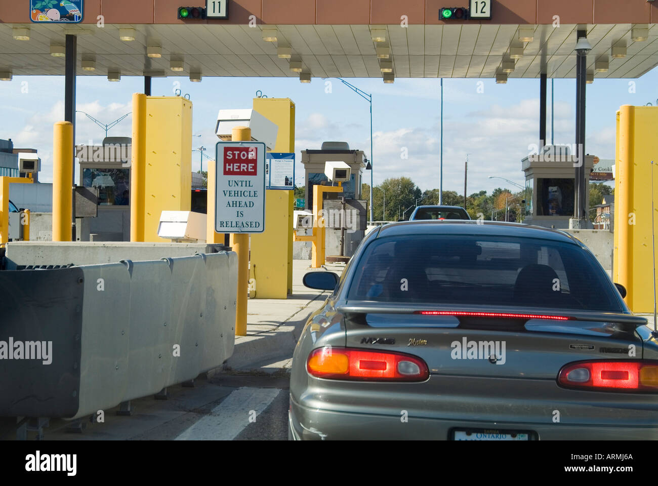 Customs and immigration agents check automobiles entering the U S ...