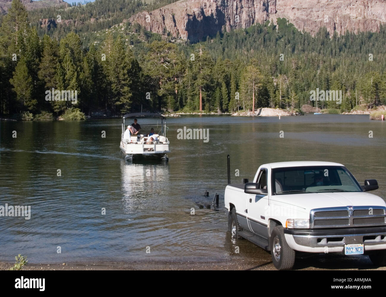 Pickup truck picking up a pontoon boat at the Silver Lake boat ramp in ...