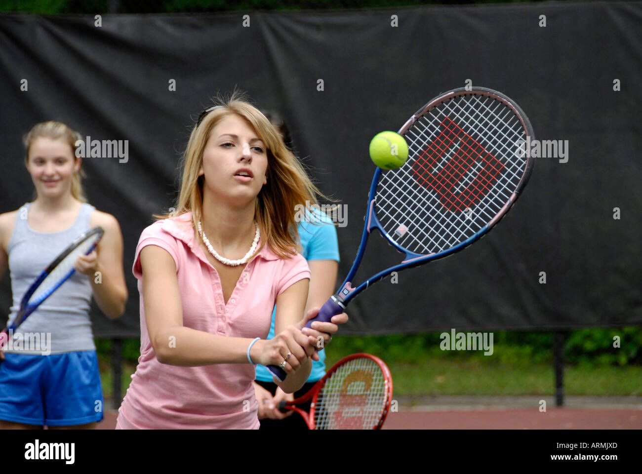 Middle school and high school age teenagers take Tennis lesson in a ...