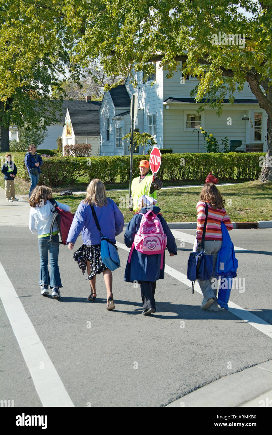 Elementary school crossing guard provides safety to children crossing ...