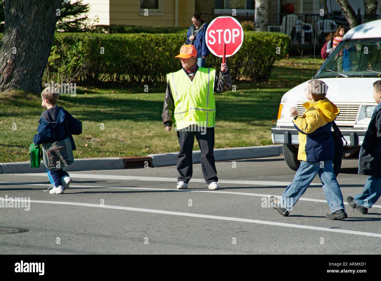 Elementary school crossing guard provides safety to children crossing ...