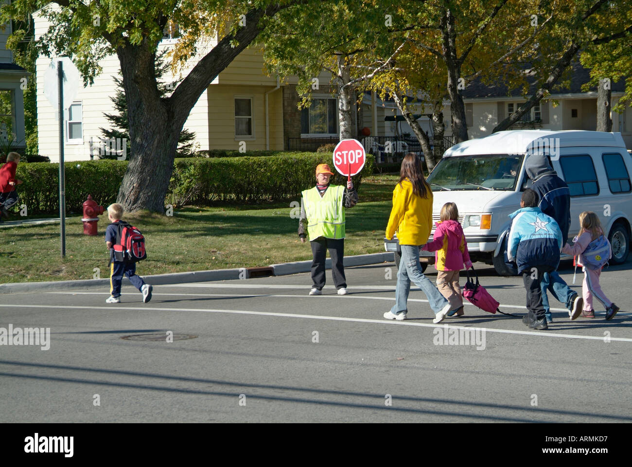 Elementary school crossing guard provides safety to children crossing ...